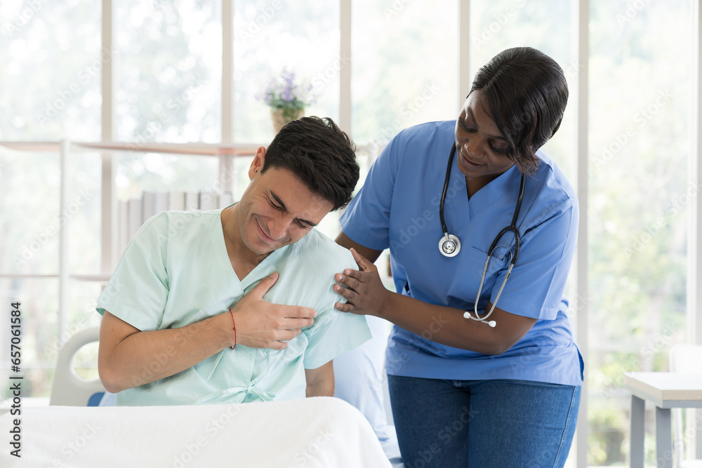 Nurse caring male patient with careful on bed at hospital. Female ...