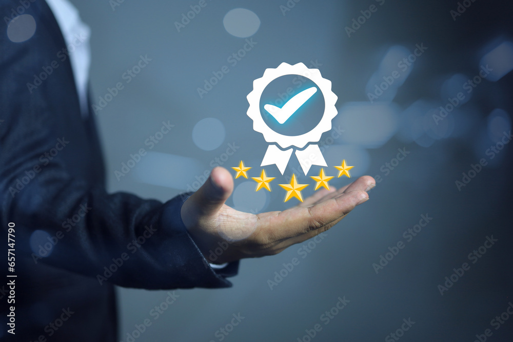 Businessman holding a 5 star quality certification mark, indicating the impressive and high ...