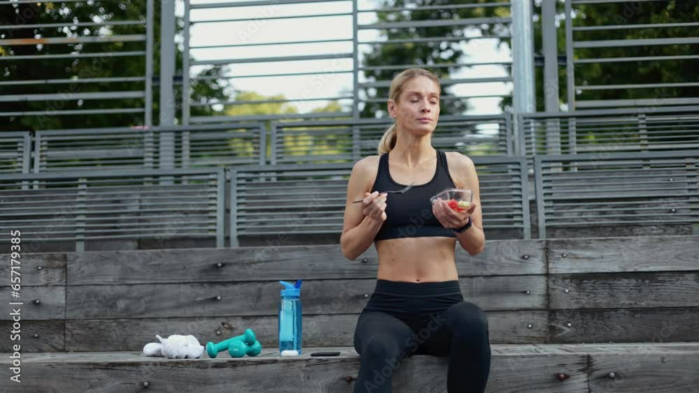 Healthy caucasian woman eating chopped tomatoes and cucumbers after ...
