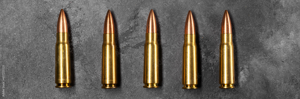 Bullets for Kalashnikov assault rifle on gray concrete and gradient ...