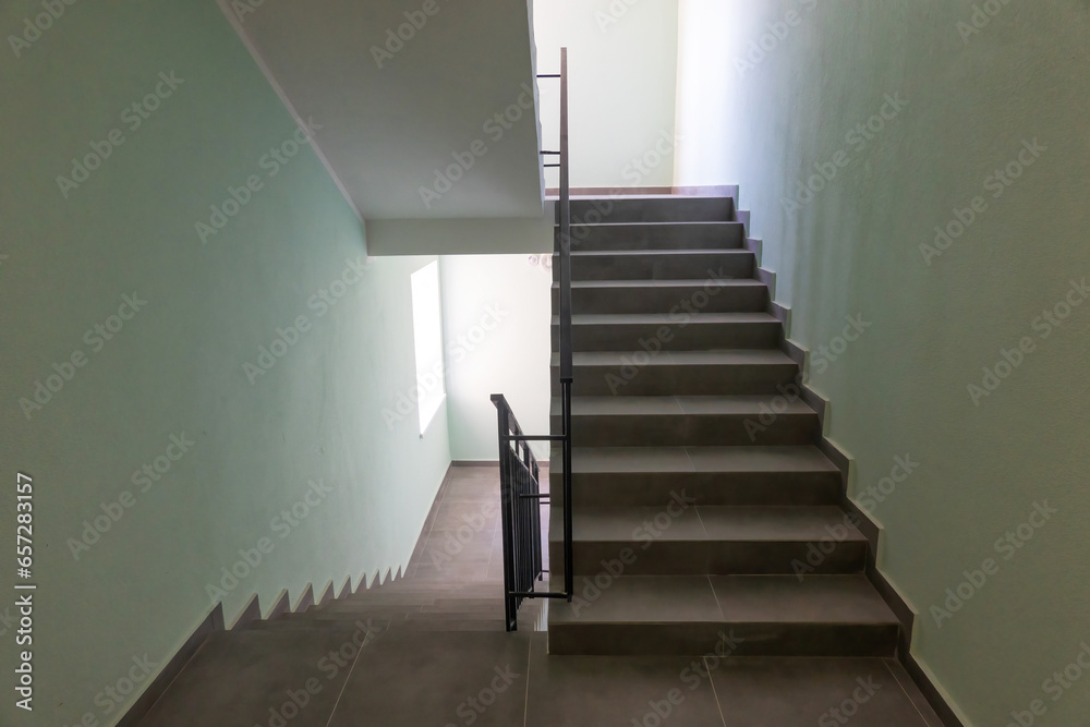 Staircase of a modern multi-storey building. Lots of light from the ...