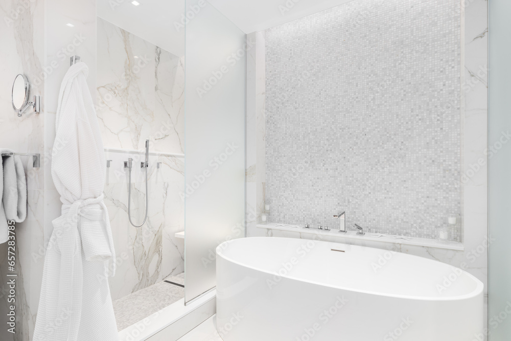 A bathroom detail with a free standing soaking tub in front of a wall ...