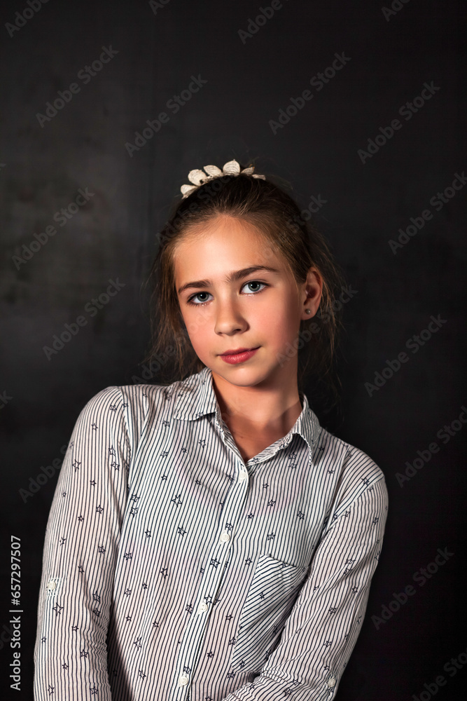 Portrait of little girl 9-10 year old in casual attire posing at black ...