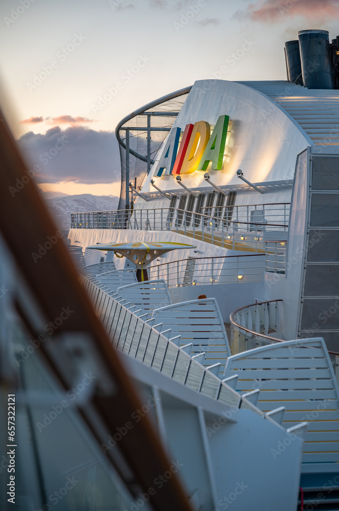 Illuminated AIDA Logo at AIDA Bella cruise ship during sunset fence of ...