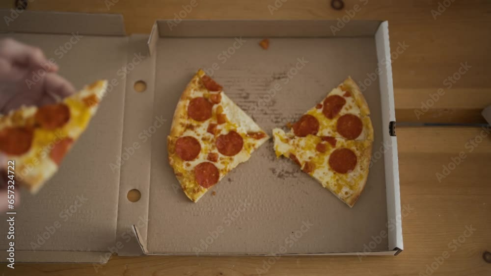 Top view of hands opening pizza cardboard box and taking slices of ...