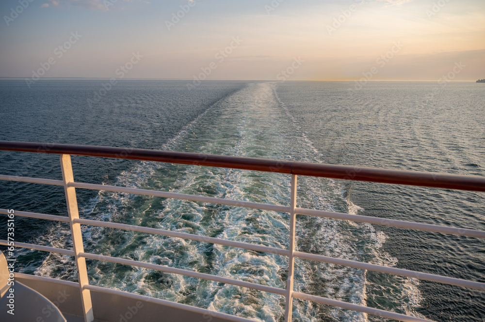Backside of a cruise ship with ship railing in front and sea in the ...