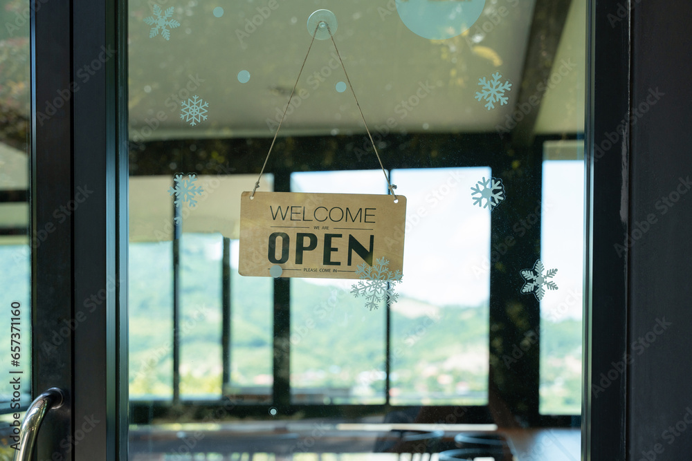 A business sign that says Open on local businesses hang on door at ...