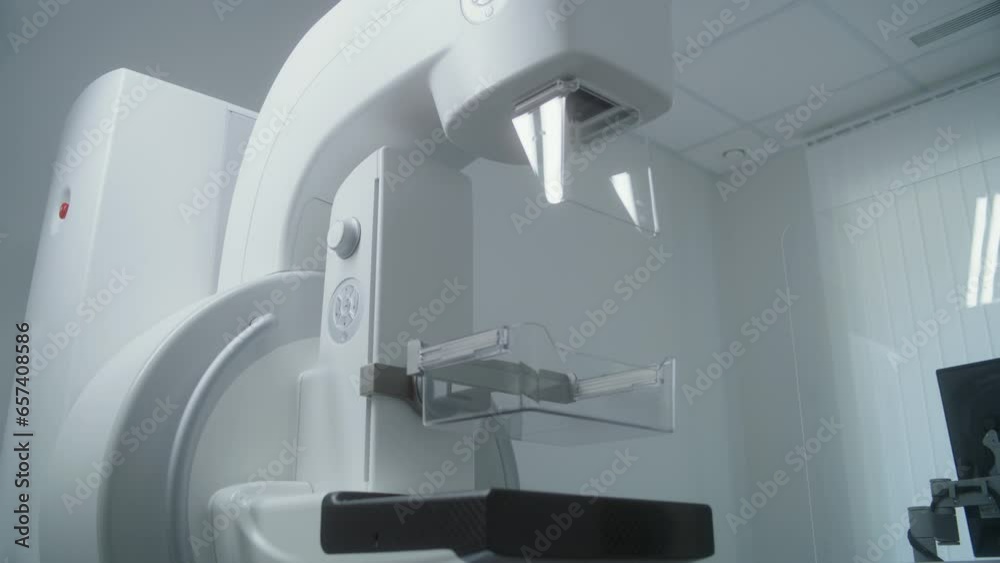Hospital radiology room. Professional female doctor adjusts digital ...