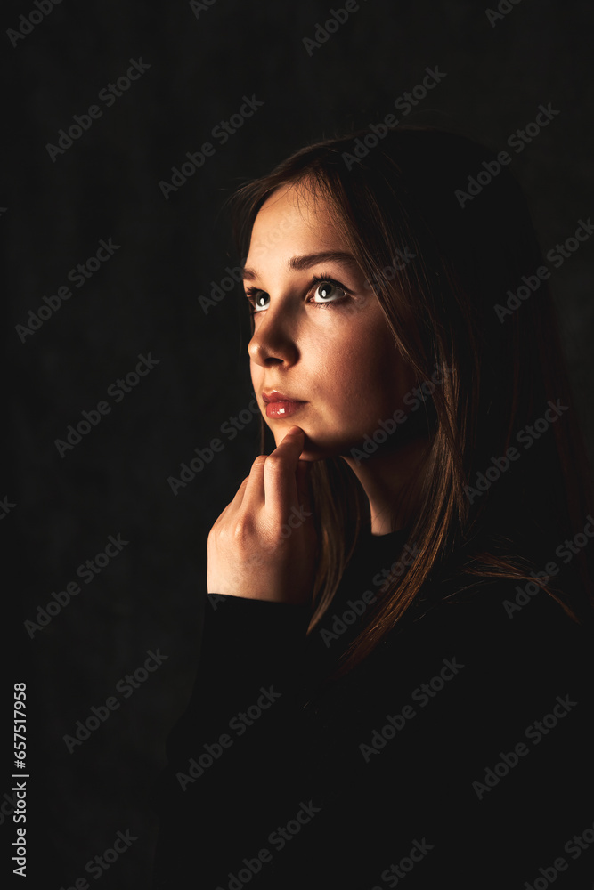 Face of charming teenager cover girl in black posing at dark backdrop ...