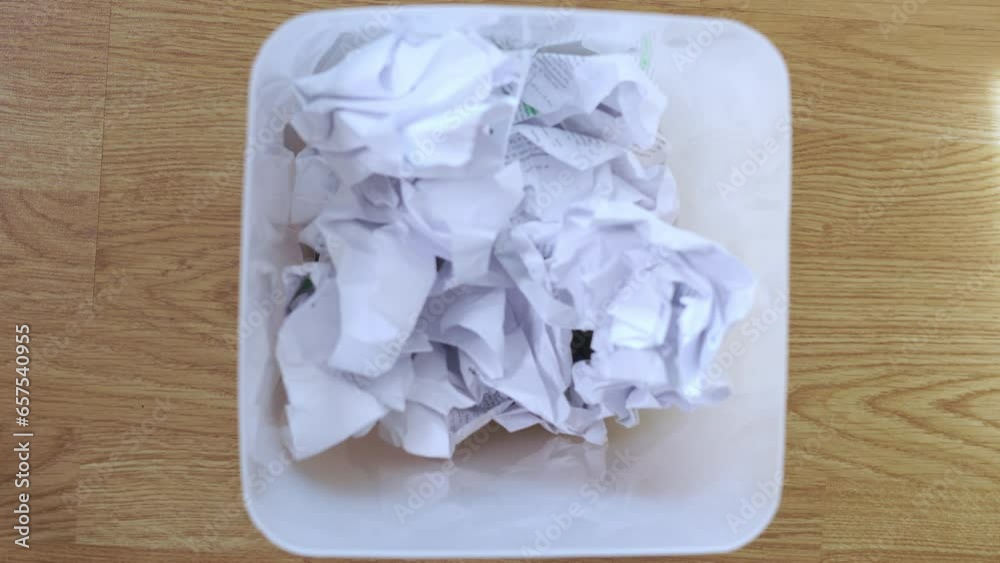 People hand throws the crumpled paper, hinting at the feeling of ...
