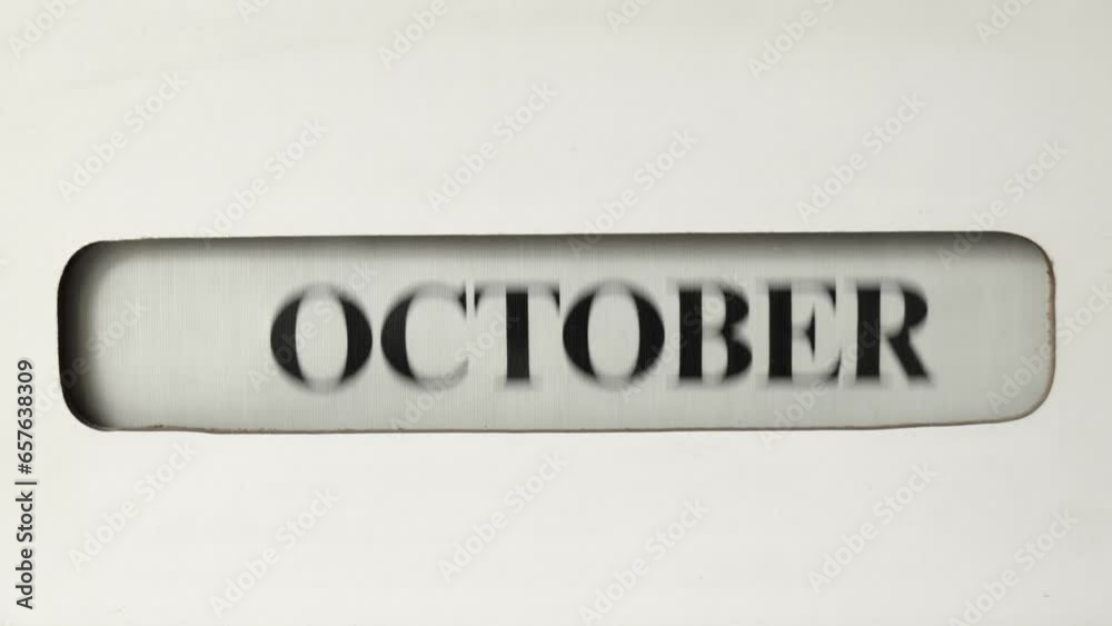 A retro office calendar is seen scrolling backwards through the months ...