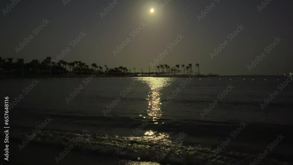 Moon on the background of the Red Sea. The moon rises from the water ...