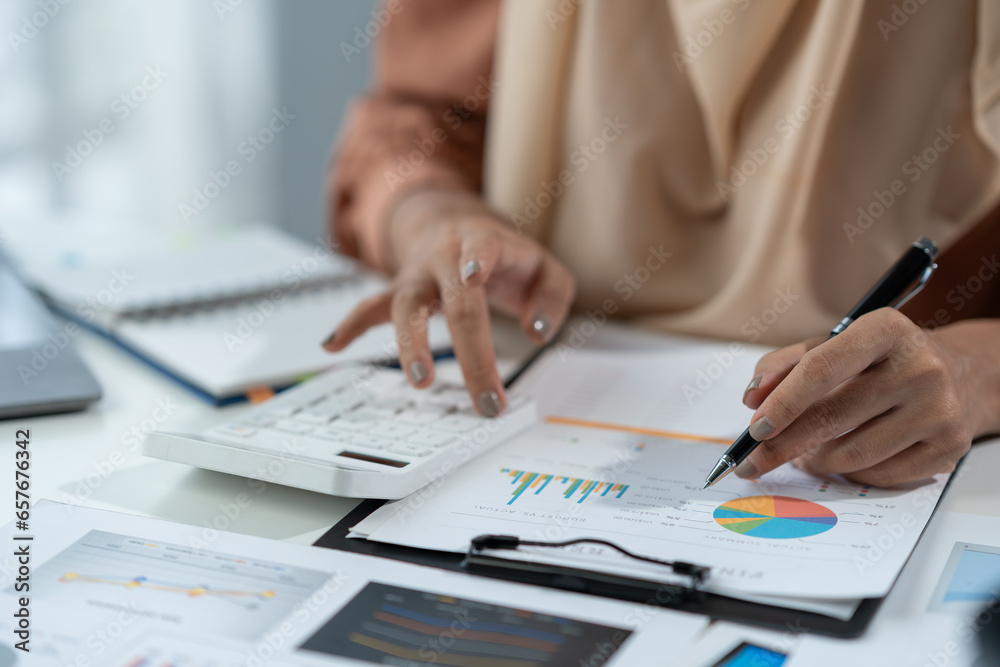 Motivated muslim businesswoman wearing hijab working on real estate ...