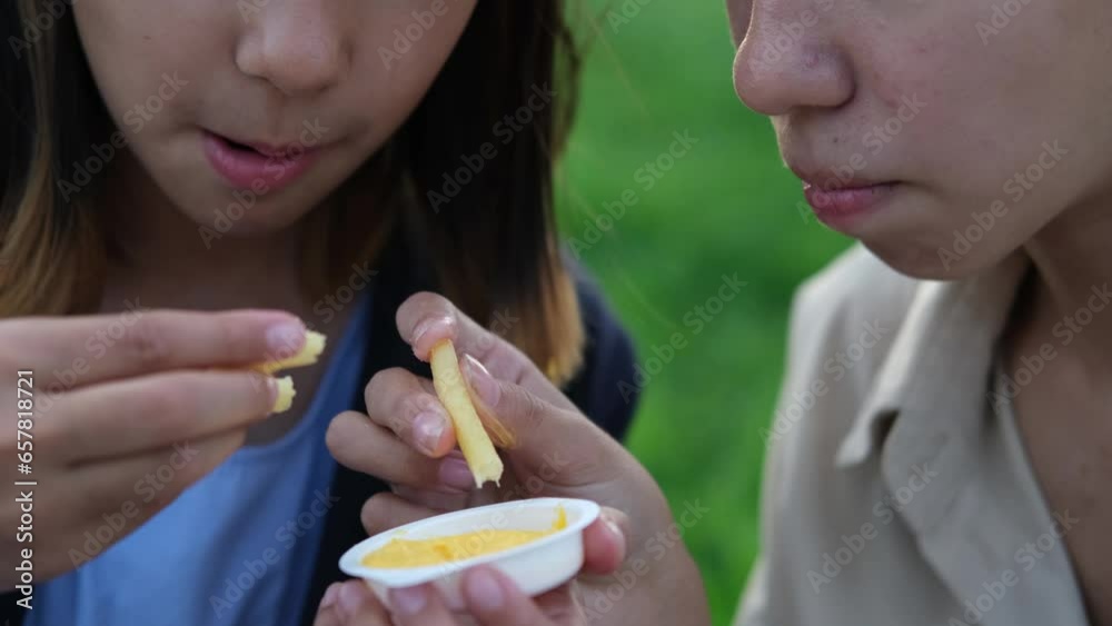 Cute children, two sisters eating French fries outdoors in summer ...