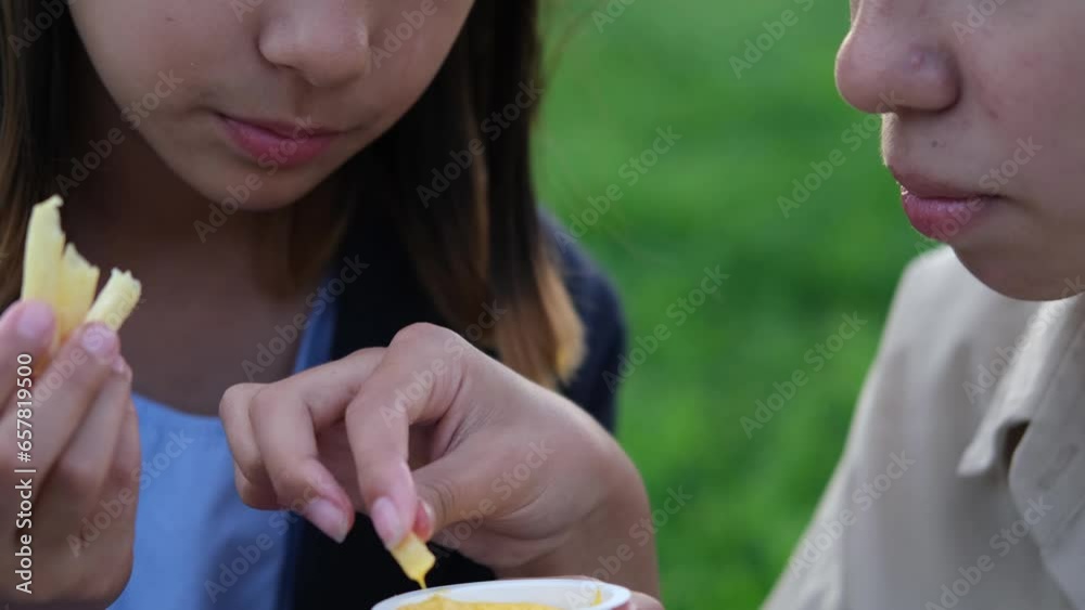 Cute children, two sisters eating French fries outdoors in summer ...