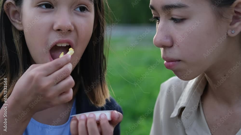 Cute children, two sisters eating French fries outdoors in summer ...