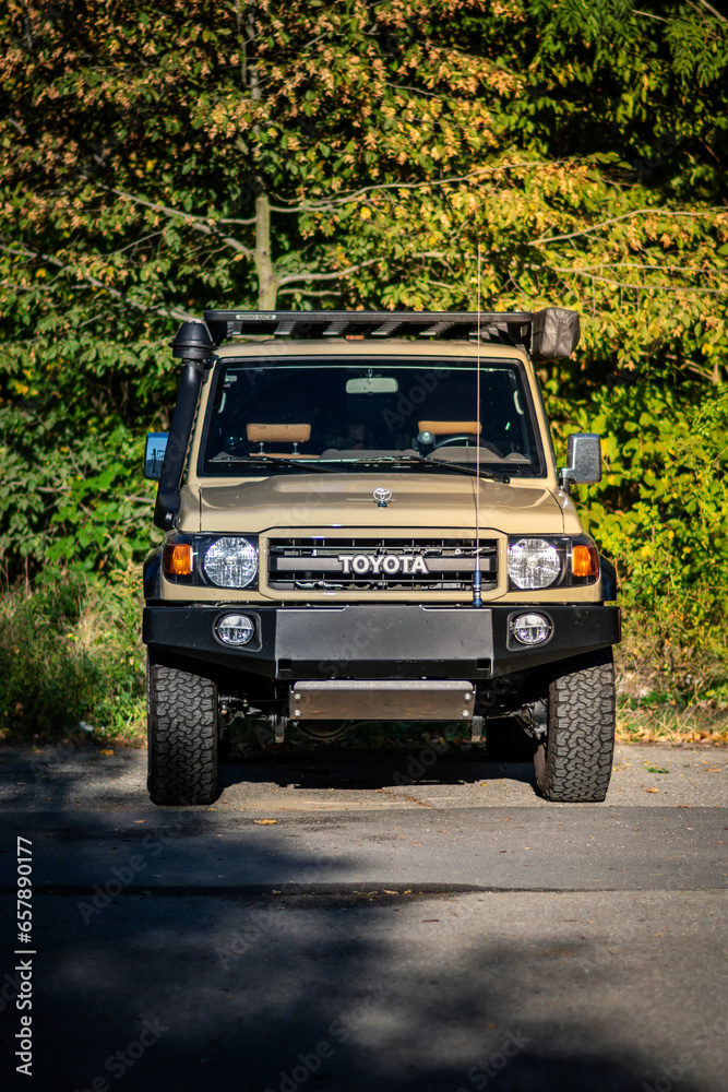 Beige Toyota Land Cruiser SUV parked outside in the forest. Off-road ...