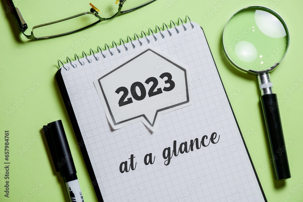 2023 At a glance text on notepad on green background. 2023 Year in ...