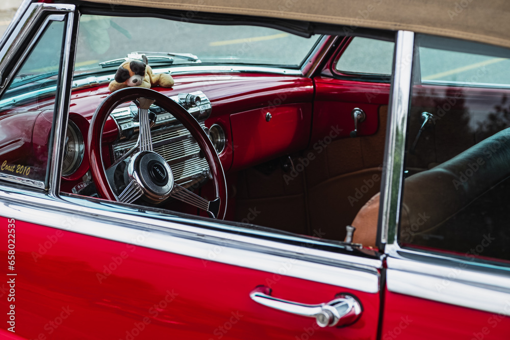 Old vintage interior of a red car with steering wheel and cockpit ...