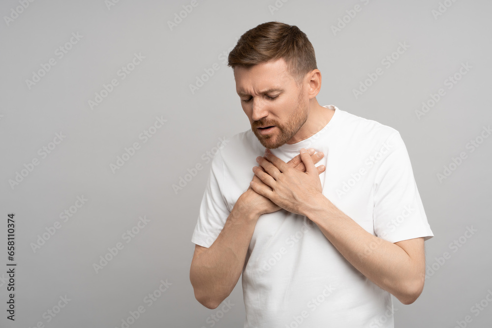 Breathing problem. Man holds on to chest suffering from heartburn ...
