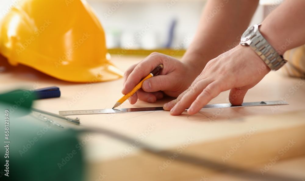 Arms of worker making structure plan on scaled paper closeup. Manual ...