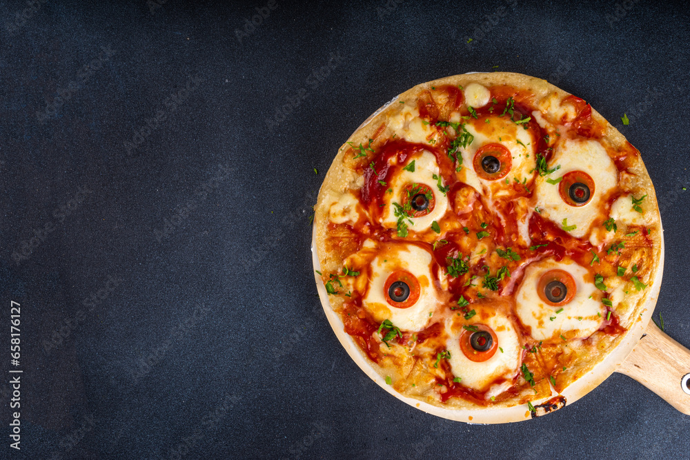 Funny creepy Halloween pizza with eyes made from cheese, tomatoes and ...
