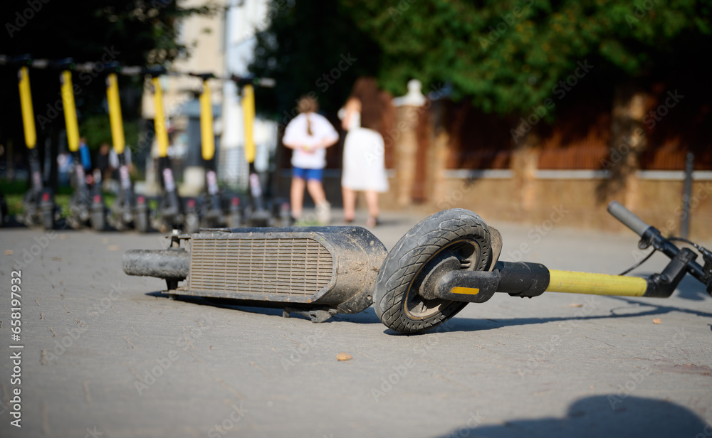 Broken electric scooter lies on the road. Rent a scooter. Urban ...