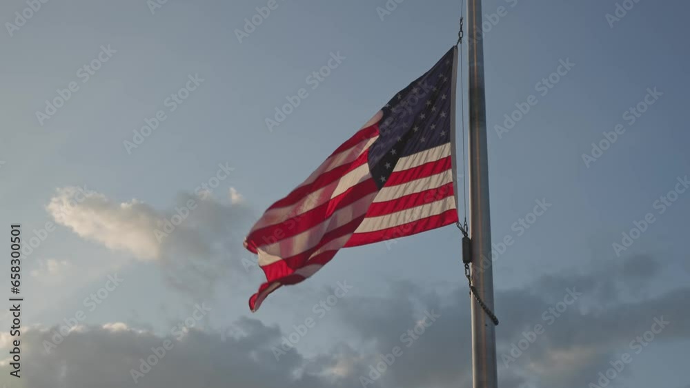 Red, white, and blue American Flag blowing and flowing in the wind in a ...