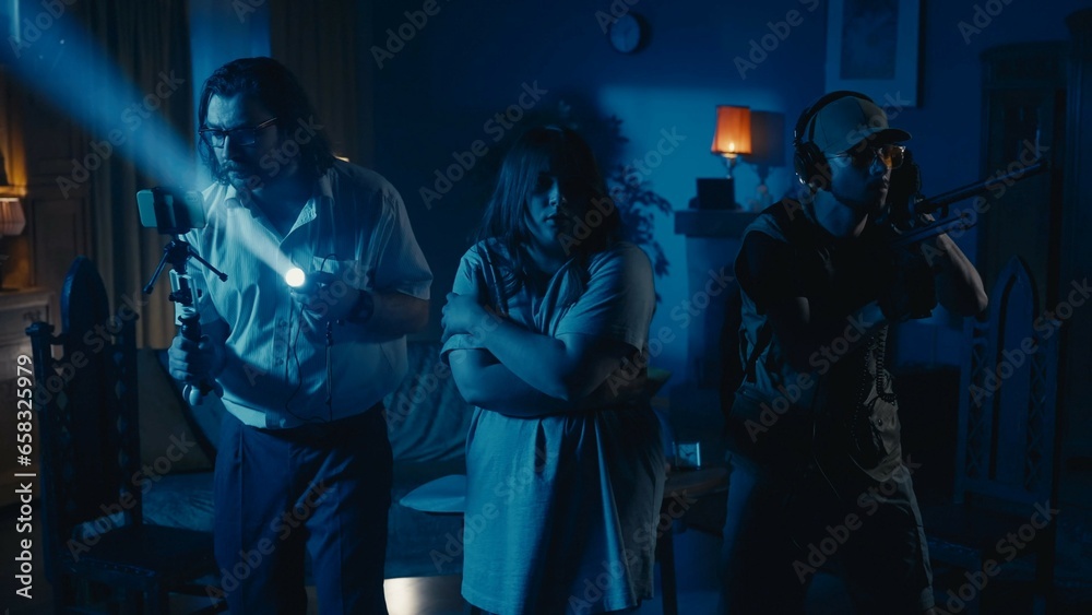 Medium-full photo capturing two ghost hunters and a victim going around ...