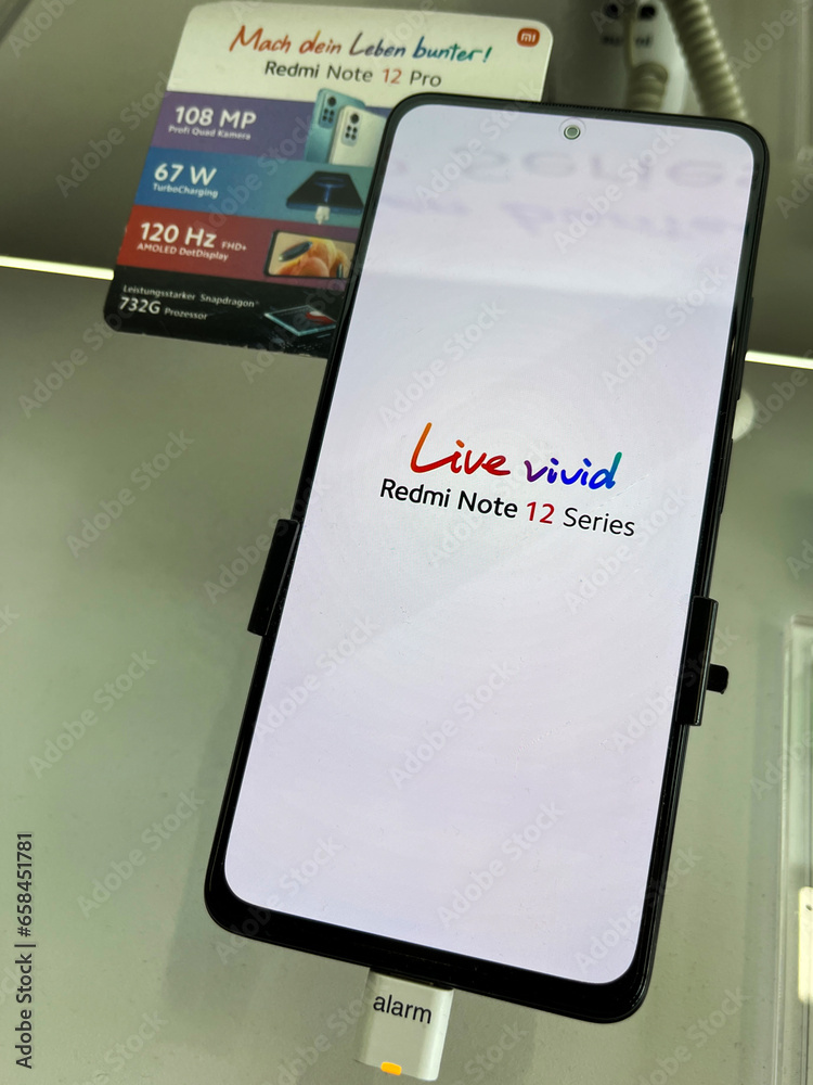 Explore the Redmi Note 12 Series smartphone showcased at a stand in a ...