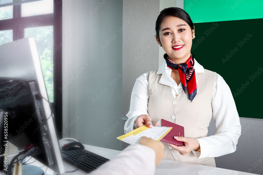 Beautiful Asian female passenger service agent receives passport ...