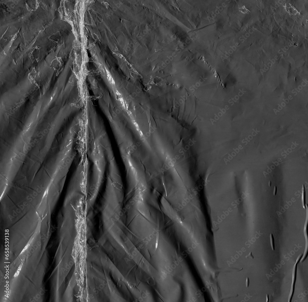 Wrinkled plastic wrap texture on a black background wallpaper. Royalty ...