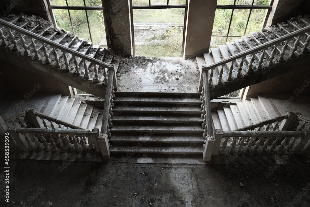stone staircase with concrete railings and an old big window in ...