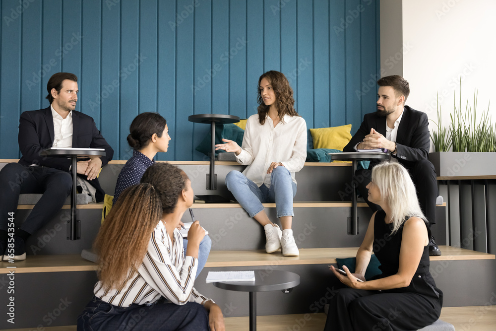 Young creative employee sharing ideas with business team on ...