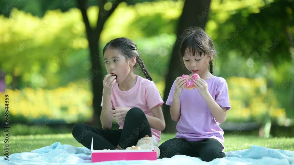 Cute little Asian children eating sweet donuts, tasty food for kids ...