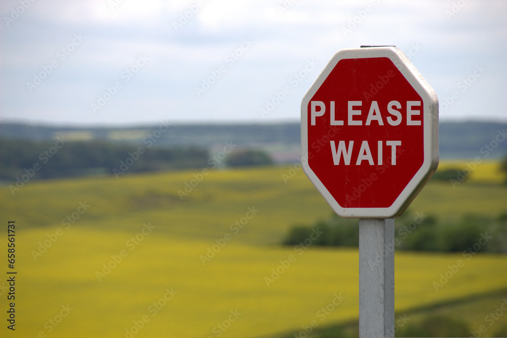 Please wait red road sign Stock Photo | Adobe Stock