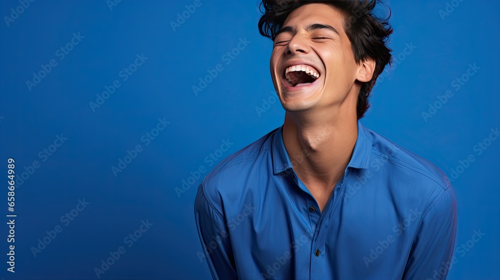 Joyful Moment in Cobalt. A handsome model, beaming with a genuine laugh ...