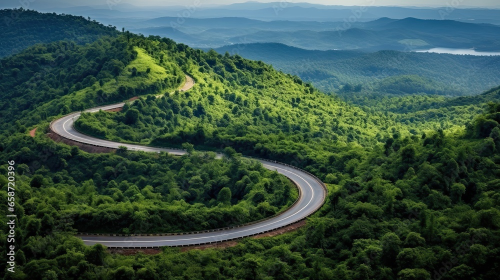 Aerial top view beautiful curve road on green forest in the rain season ...