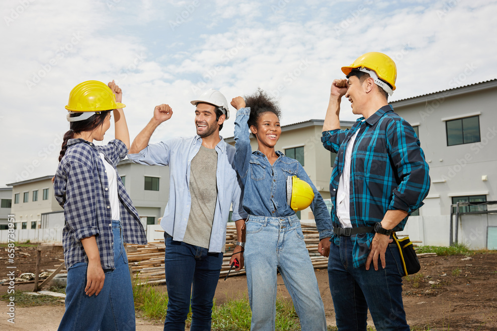 group of workers or architect celebrating success at work and project ...