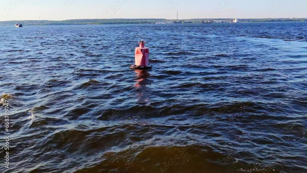 Red metal buoys on the water in the Volga River on the way of a ferry ...