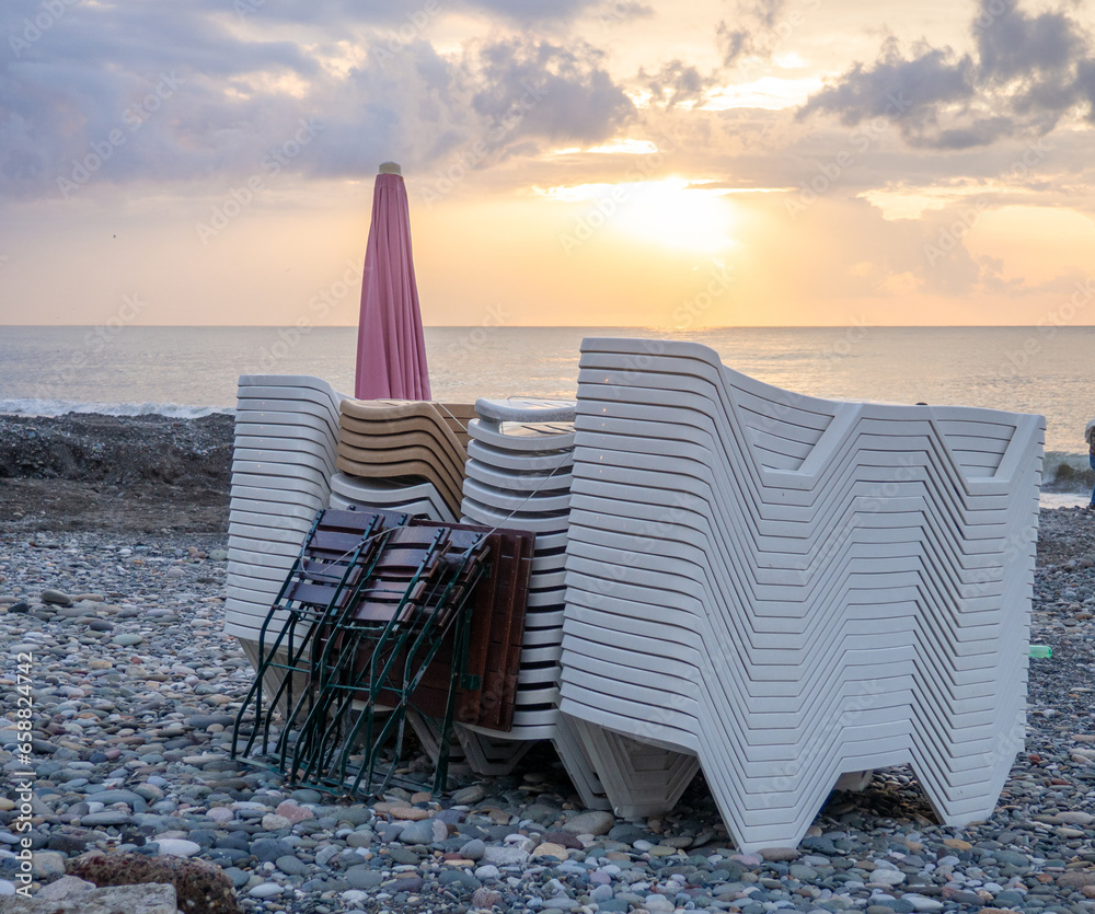 Folded sun loungers. End of season at the resort concept . The rest is ...