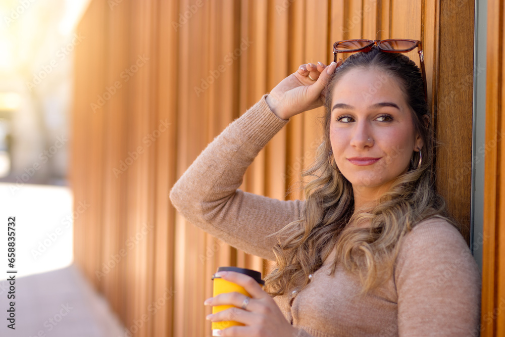 Determined young woman raising her glasses as a symbol of confidence ...