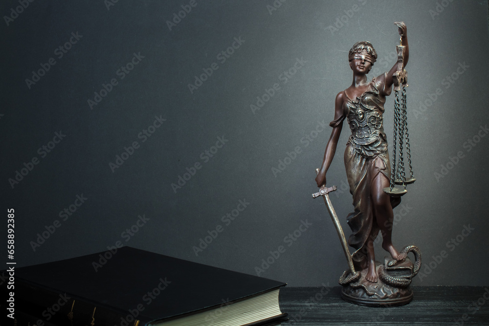 Law concept - open book of laws, scales, Themis symbol on the table in ...