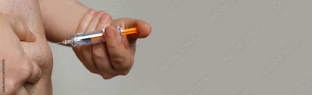 Human hand holding syringe and making self injection in belly on white ...