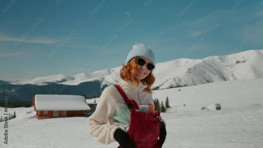Red haired tourist in the mountains raising hand at eye level to see ...