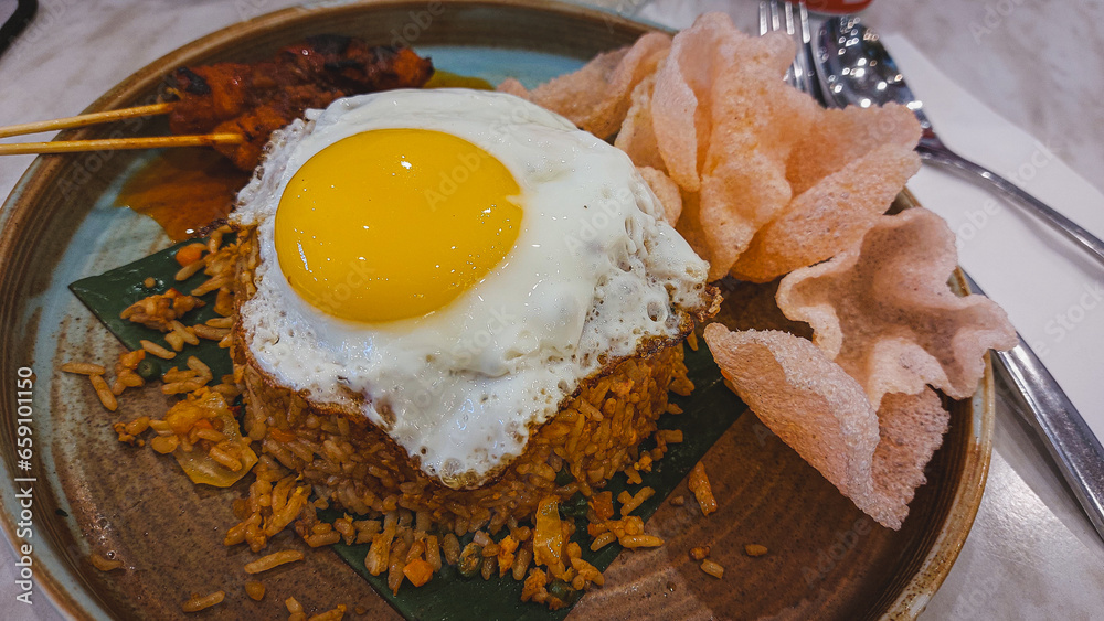 Malaysian fried rice or nasi goreng with chicken satay, fried egg and ...