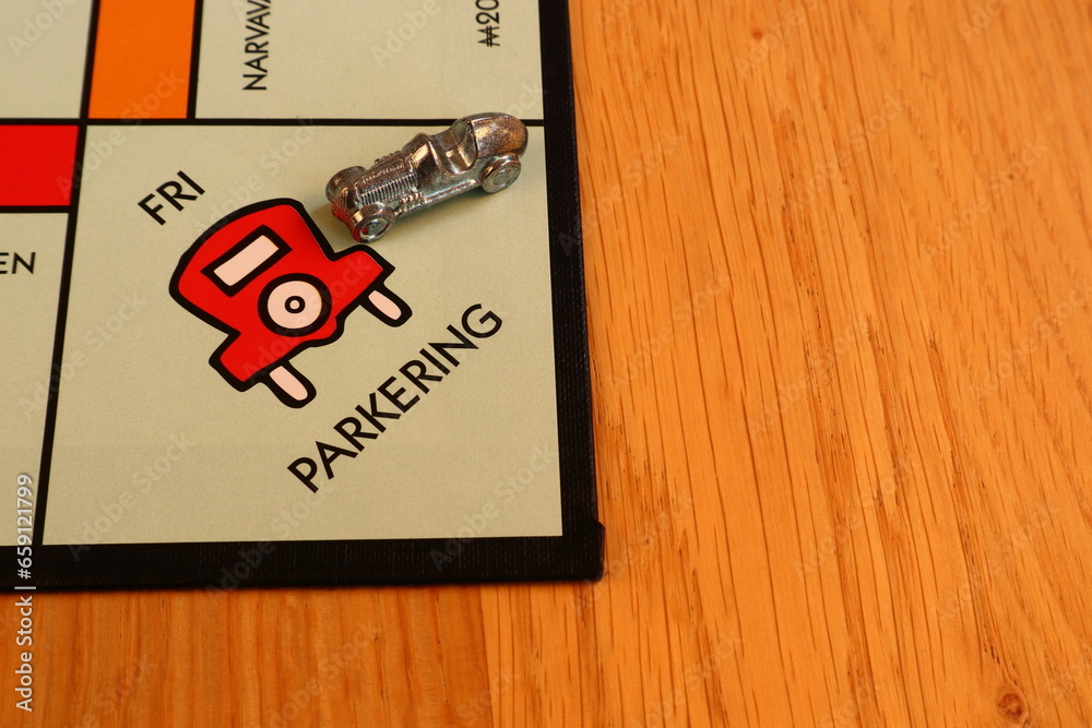 Monopoly board game. Free parking symbol. Metal car token parked. Close ...