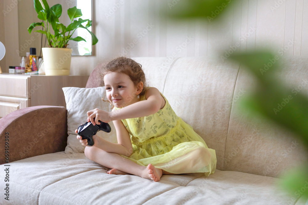 little girl playing VIDEO controller console station, holding gamepad ...