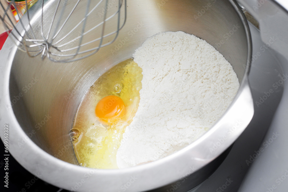 Mixing ingredients. Metal bowl with cracked egg and flour. Pancake ...