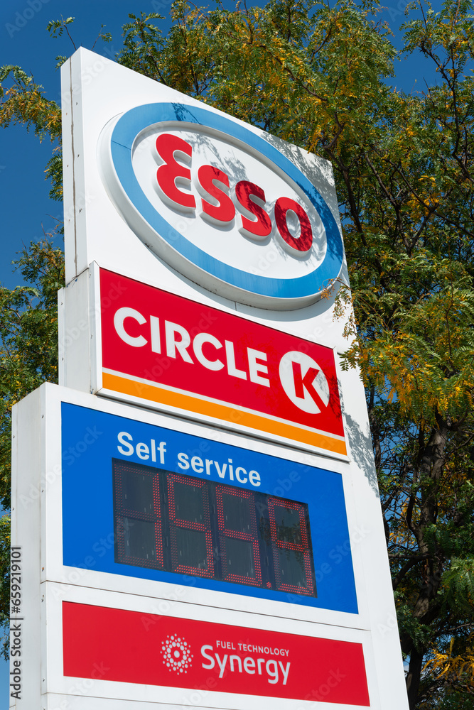 exterior lighted sign of Esso, Circle K and information about the price ...